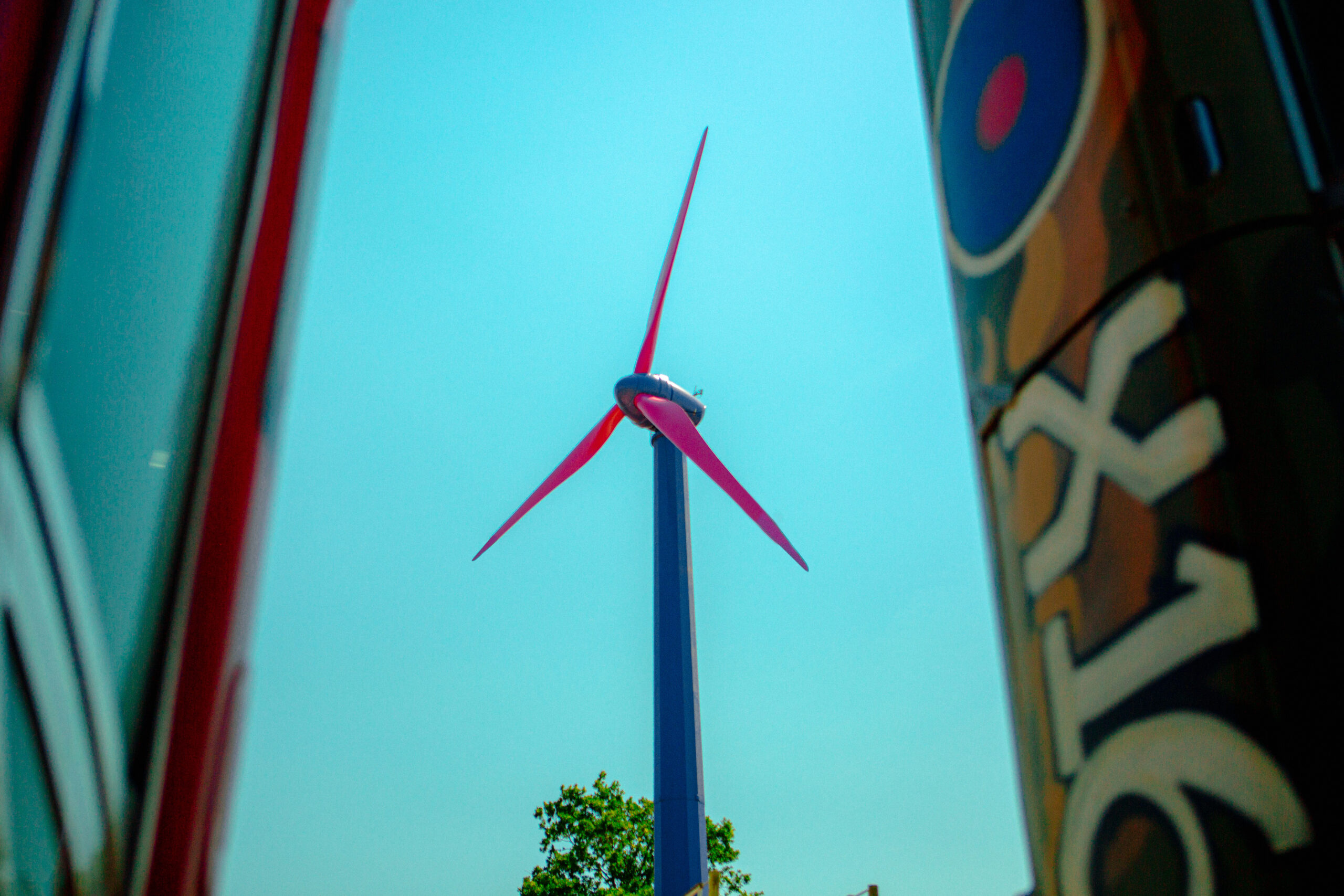 Green energy firm installs 28m pink and purple wind turbine at ...